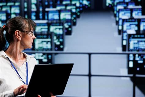 Premium Photo Experienced Technician In Data Center Working On Laptop
