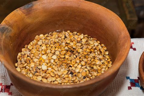 roasted yellow corn kernels soaking in water inside a clay pot stock