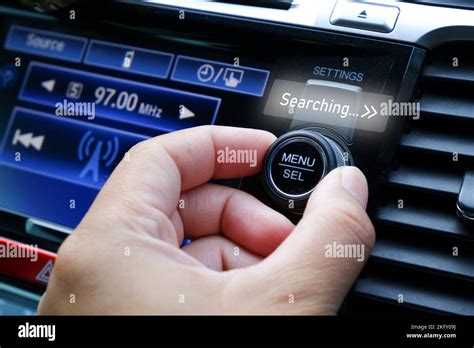 The Driver Adjusts His Hand To Seek For A Radio Station On The