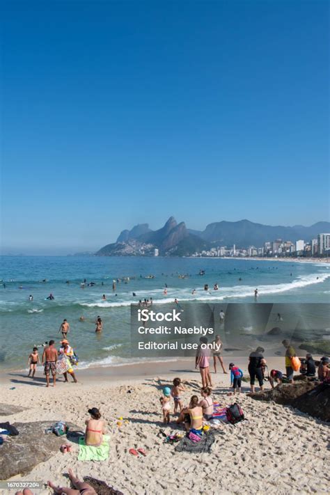 Rio De Janeiro Brazil People Sunbathing Swimming And Surfing At Ipanema