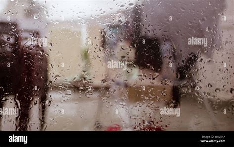 Rain Drops On Surface Of Wet Window Glass Pane In Rainy Season