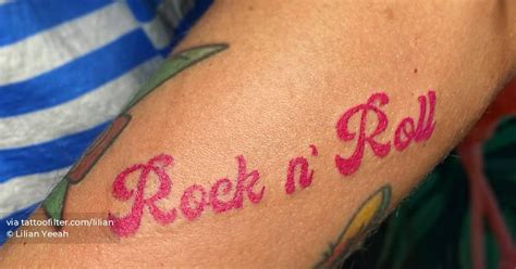 Rock N Roll Lettering Tattoo Located On The Forearm