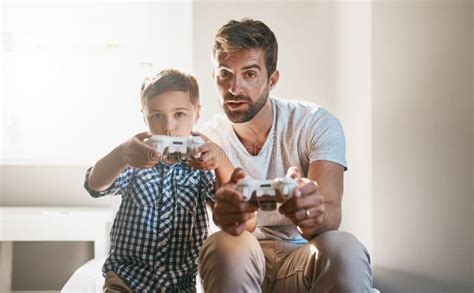 Father Portrait And Son Playing With Controller For Video Games Entertainment Or Bonding