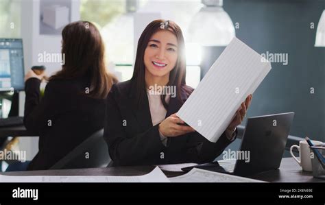 Portrait Of Designer Analyzing 3d Architectural Model With Printed Maquette In Shared Workspace