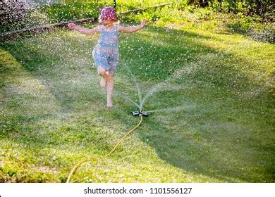 3 Hundred Running Through A Sprinkler Royalty Free Images Stock