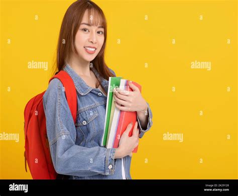 Beautiful Asian Girl College Student Smiling And Holding Books Stock