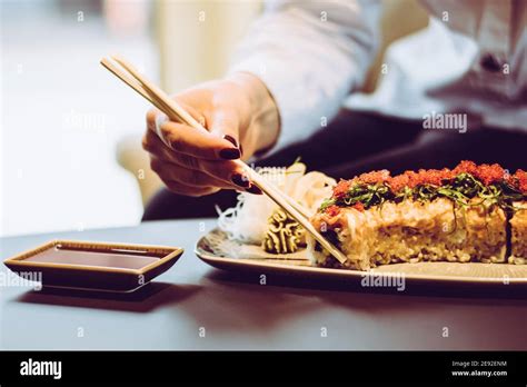 Woman Eating Sushi At A Restaurant Stock Photo Alamy