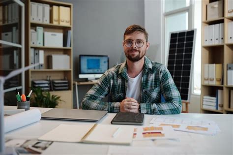 Premium Photo Engineer At Table With Construction Document