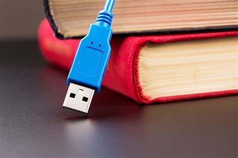 Premium Photo Usb Cable Is Lying On Books