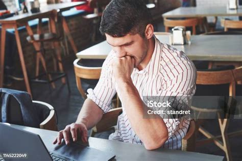 프로젝트에 대 한 걱정 성인 남자는 낮에 카페에 앉아 원격 작업을 위한 노트북을 사용 하 여 걱정하는에 대한 스톡 사진 및 기타
