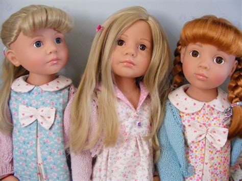 three dolls are standing next to each other