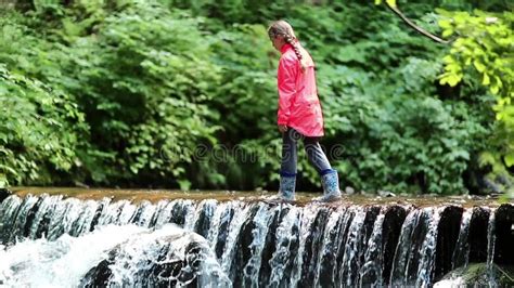 Girl In Red Jacket Walks Along Small Overflow Dam On The River In The Forest Stock Video Video