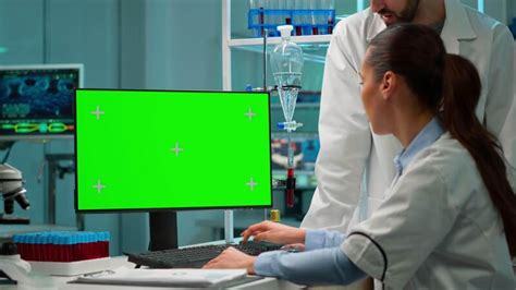 Medical Research Scientists Using Desktop Computer With Green Screen Mock Up Template In Applied