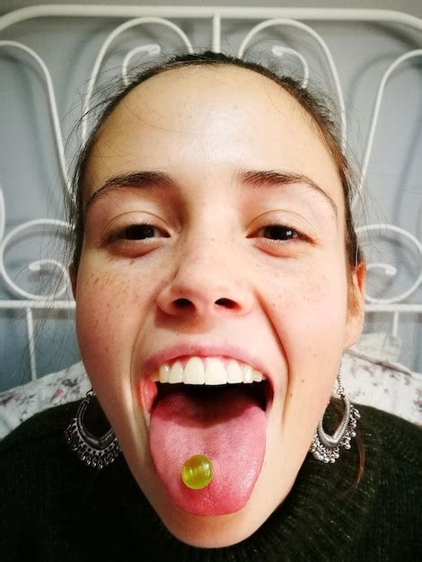 Premium Photo Close Up Portrait Of Woman Eating Candy At Home