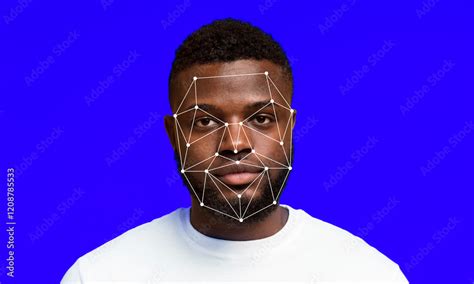 A Man Stands Against A Bright Blue Background While A Facial