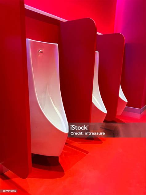 Closeup Image Of Row Of Modern White Ceramic Urinals In Public Washroom