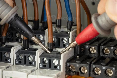 Testing Electrical Connections With Probes In A Terminal Block Stock Photo At Vecteezy