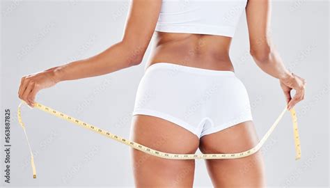 Measure Weight Loss And Woman With Tape For Sizing Body Isolated On A Grey Studio Background