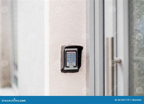 Intercom System With A Keypad Is Mounted On A Beige Textured Wall Intercom System With A Keypad Is Mounted On A Beige Textured Wall