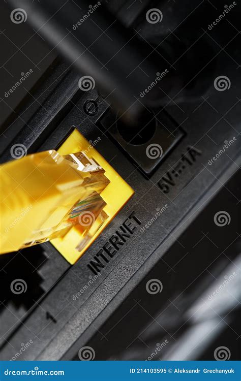 Wireless Modem Router With Yellow Cable And Lan Port For Connection On A Black Background Stock