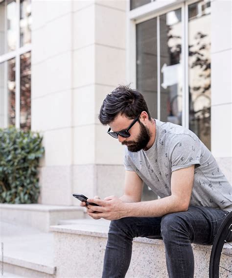 Man Typing On His Phone By Stocksy Contributor MEM Studio Stocksy