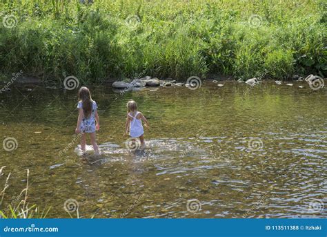 Two Pretty Girls At The River Enjoy The Waters And Nature Editorial