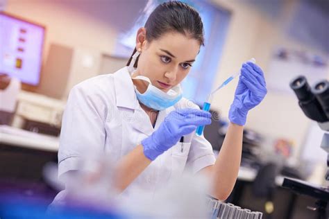 Liquid Woman And Scientist With Test Tube And Dropper In Laboratory