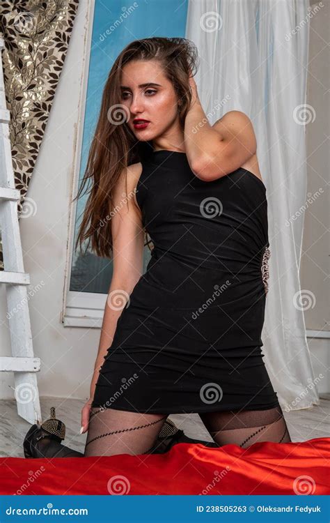 Slim Brunette Woman Posing In Bed Looking At Camera Lady Wearing Sensual Lingerie Stock Image