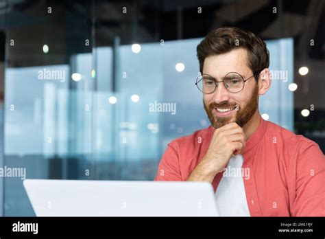 successful smiling man working inside office with laptop businessman