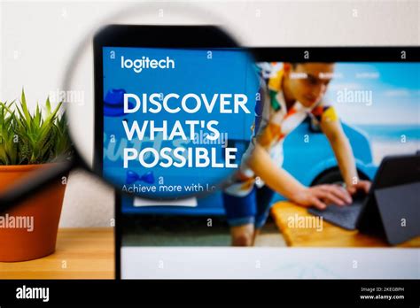 A Logo Of Logitech On A Laptop Screen Under A Magnifying Glass Stock