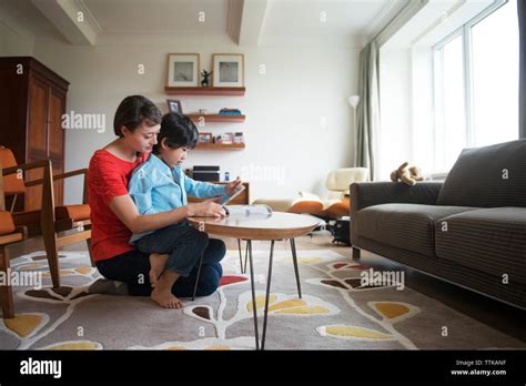 Mother And Son Using Tablet At Home Stock Photo Alamy