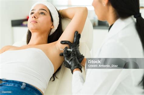 Female Patient Receives A Botulinum Toxin Injection For Hyperhidrosis