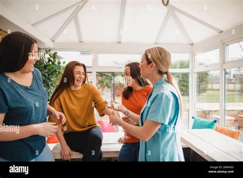 Mid Adult Beauty Sales Representative Making A Sales Pitch To A Group Of Women At A Product