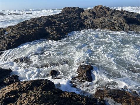 Waves Crashing On Rocks Near The Ocean