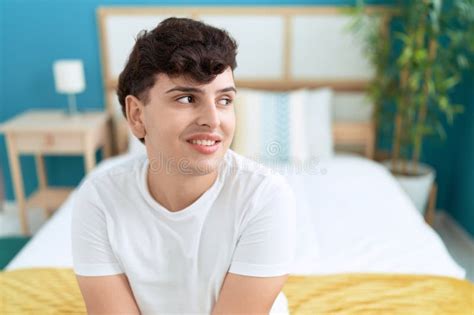 Non Binary Man Smiling Confident Sitting On Bed At Bedroom Stock Image Image Of Resting Adult