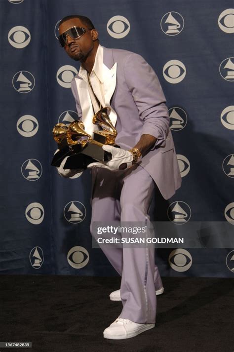 Us Rapper Kanye West Poses With The Three Awards He Won At The Grammy