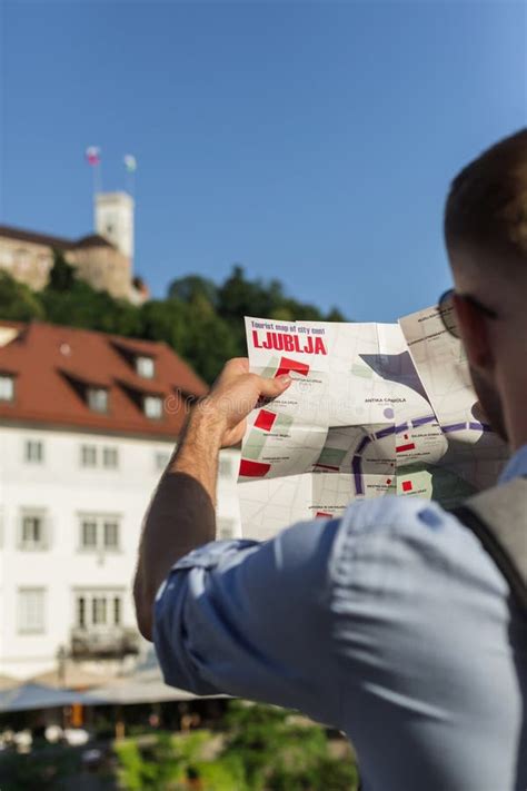 Young Man A Traveler Looking At The Tourist Map While Exploring Attractions Stock Image Image