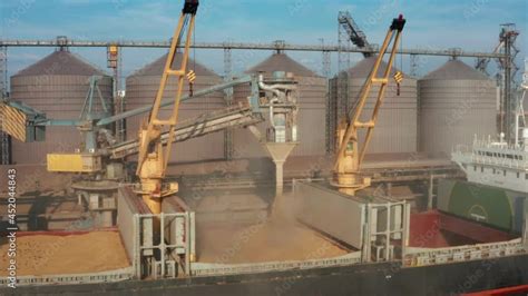 Drone Video Loading Grain Into Holds Of Sea Cargo Vessel Through An Automatic Line In Seaport