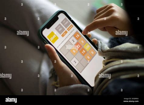 a girl plays the 2048 game on an iphone on february 15 2021 the math