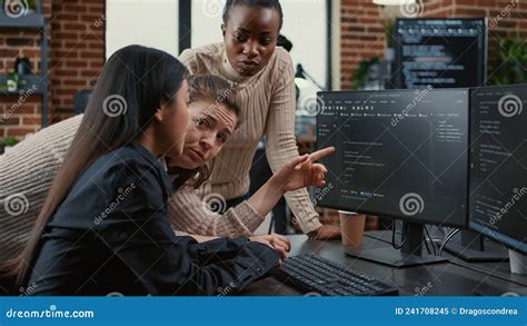 Programer Pointing At Computer Screen Explaining Running Code To Coworkers Brainstorming