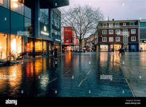 Evening Street View In Enschede With Wet Pavement Reflecting Neon