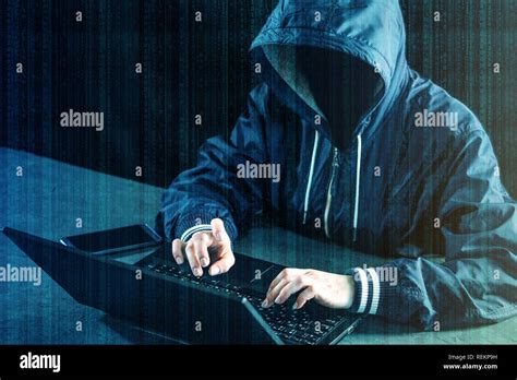 Anonymous Hacker Programmer Uses A Laptop To Hack The System Stealing