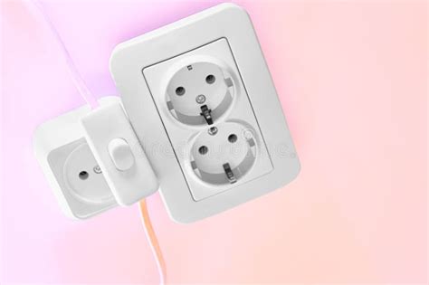 Electrical Sockets For Connecting Devices And A Switch On Pink Stock