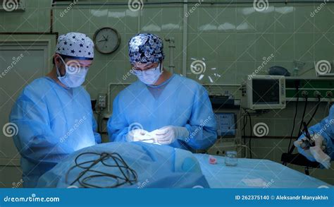 Medical Team Performing A Surgical Operation In A Modern Operating Room Microsurgery Stock