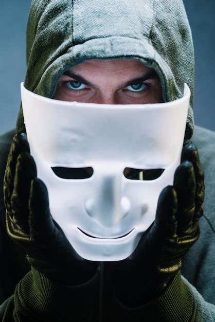 Free Photo Hacker Holding Mask