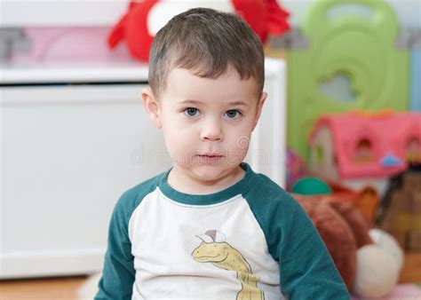 Little Boy Playing With Toys And Puzzles In His Room Stock Image