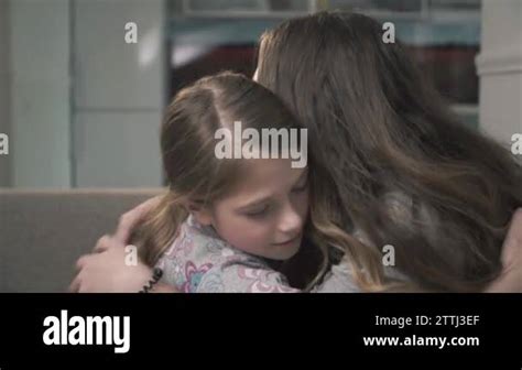 Two Sisters Cuddle Each Other Close Up Smaller And Older Girls Rub