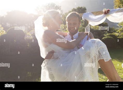 Happy Caucasian Bride And Groom Getting Married Groom Carrying Bride
