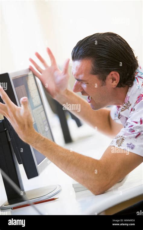 Man In Computer Room Frustrated At Monitor Stock Photo Alamy