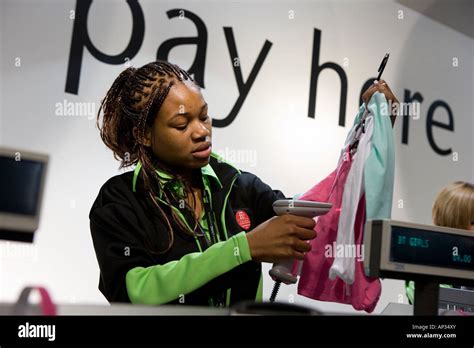 Shop Assistant At Checkout In Asda Store Tottenham North London Stock